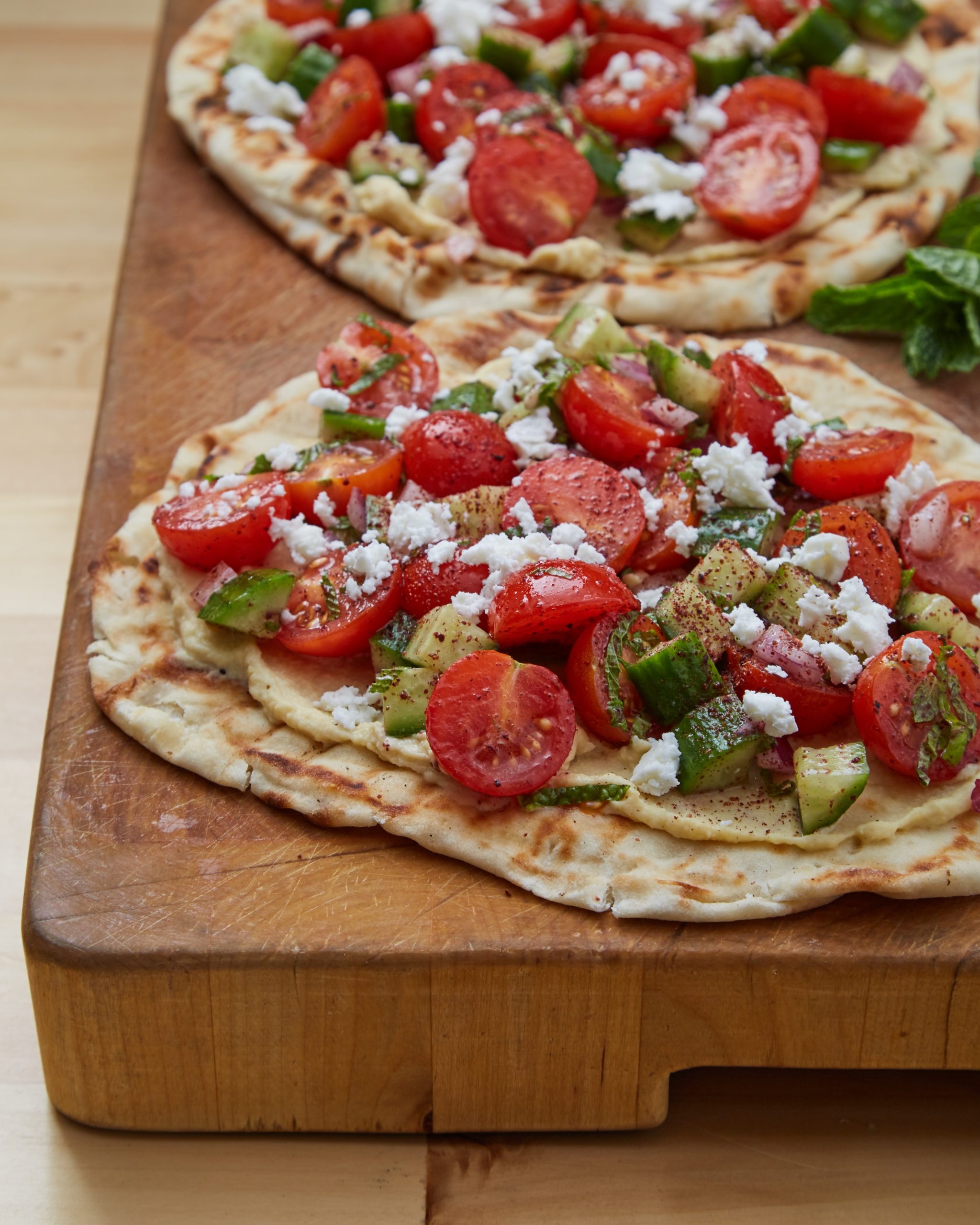 Grilled Naan Pizza With Israeli Vegetable and Cheese Topping - Rose Reisman